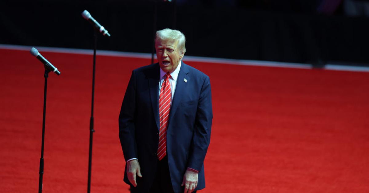 Trump signs executive orders while on stage at post-inauguration rally ...